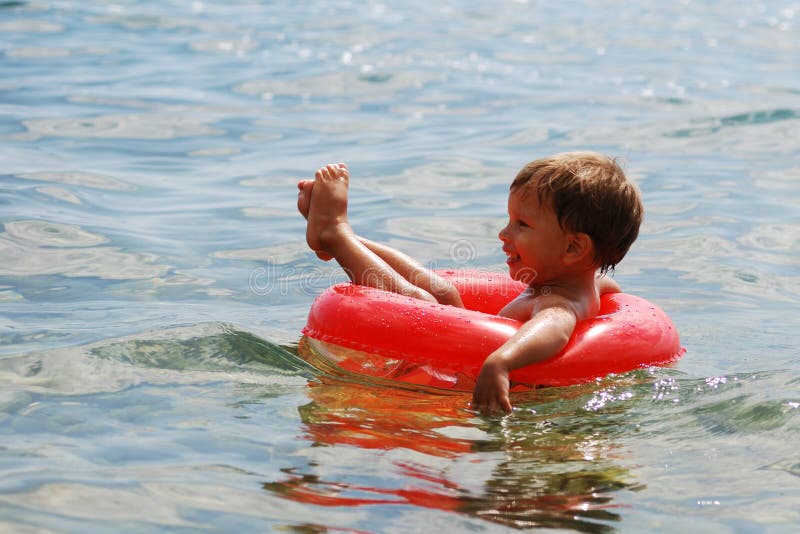 Little Boy Swimming with Red Buyoy Ring Stock Image - Image of cheerful ...