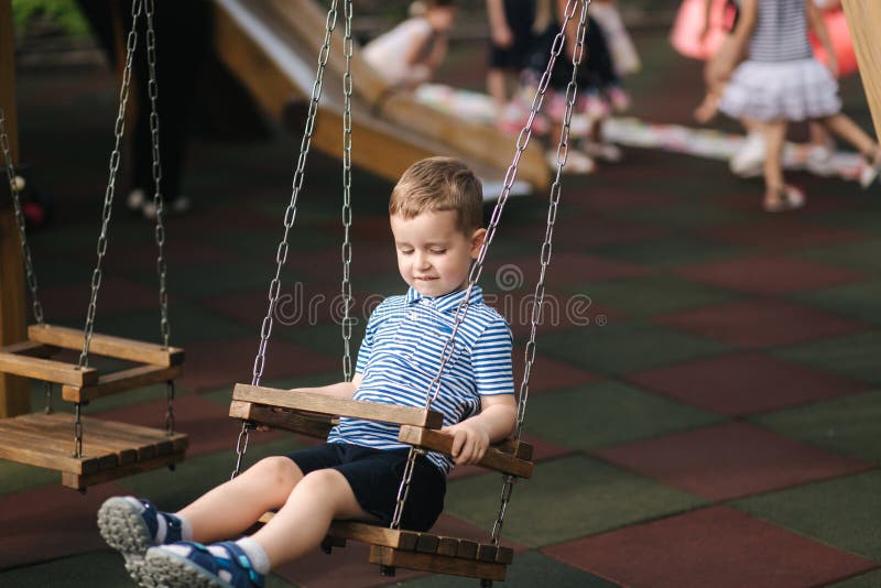 Little Boy on the Swing. Happy Kid Outdoors Stock Photo - Image of ...