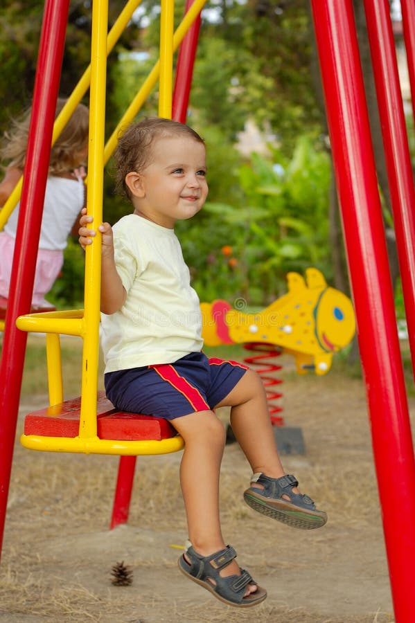 Little boy on swings stock image. Image of childhood, play - 2919625
