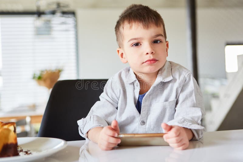 Little Boy at the Table with a Tablet Pc Stock Photo - Image of alone ...