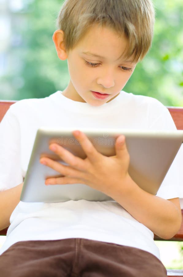 Little boy with tablet stock image. Image of reading - 34224335