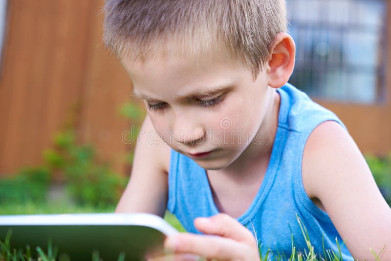 Little Boy with Tablet Pc on Grass Stock Photo - Image of little ...