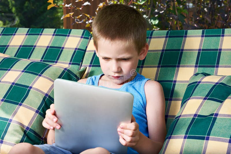 Little boy with tablet pc stock image. Image of computer - 73624061