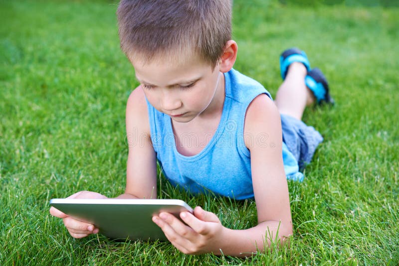 Little boy with tablet pc stock photo. Image of personal - 76659644