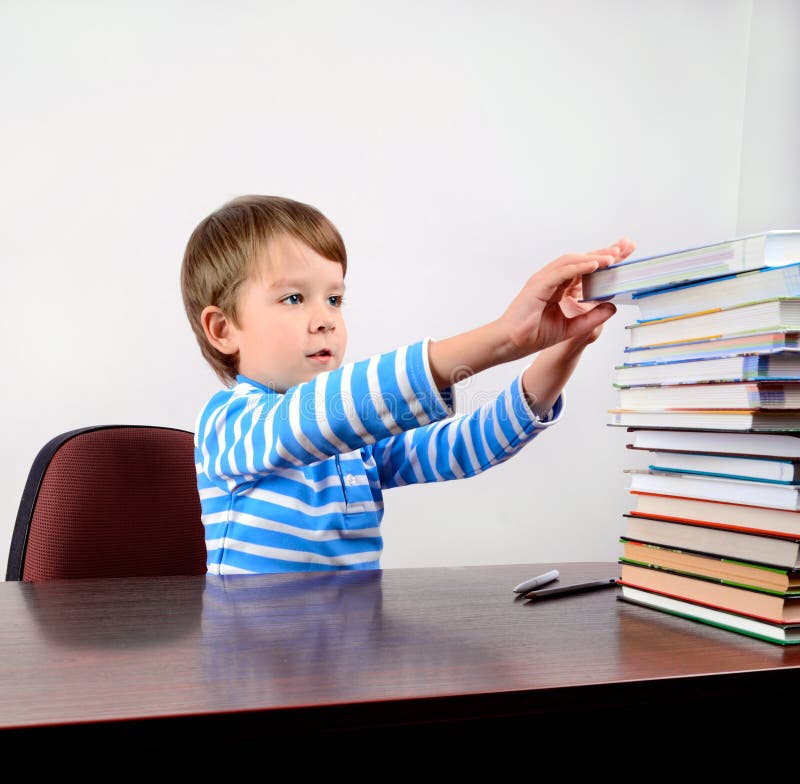 Little Boy Takes a Book from the Stack Stock Photo - Image of blond ...
