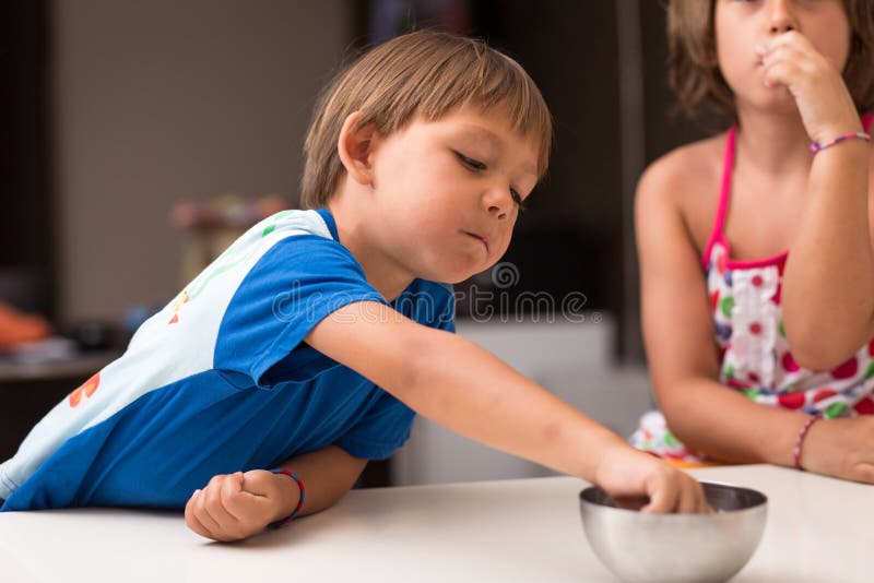 Little Boy Taking Candy from a Bowl Stock Image - Image of cook ...