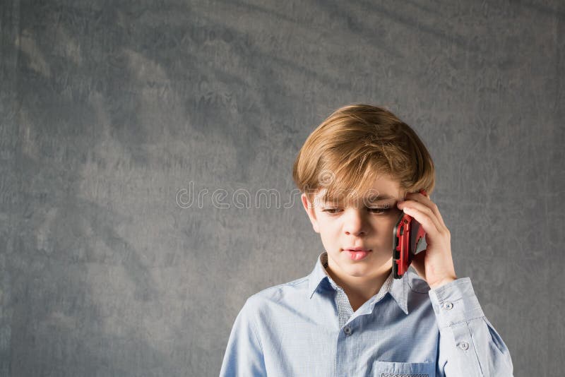 A Little Boy is Talking on the Phone Stock Photo - Image of isolated ...