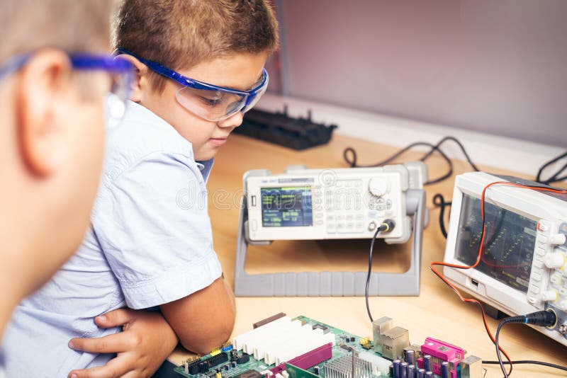 Little Boy and Teacher in Class with Electronic Project Stock Image ...