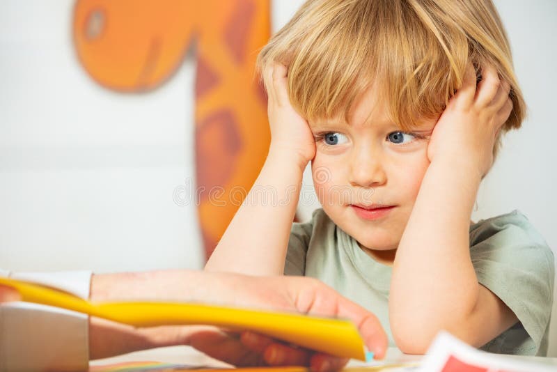Little Boy with Thoughtful Look Stare at the Page in Book Stock Image ...