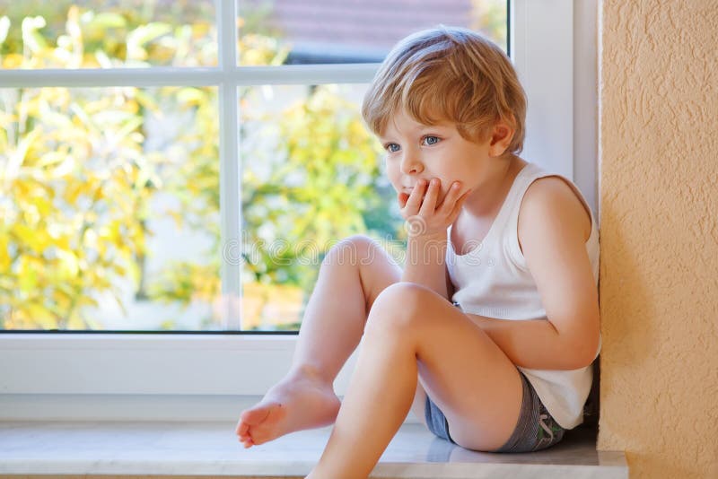 Little Boy of Three Years Looking Out of the Window on Yellow Au Stock ...