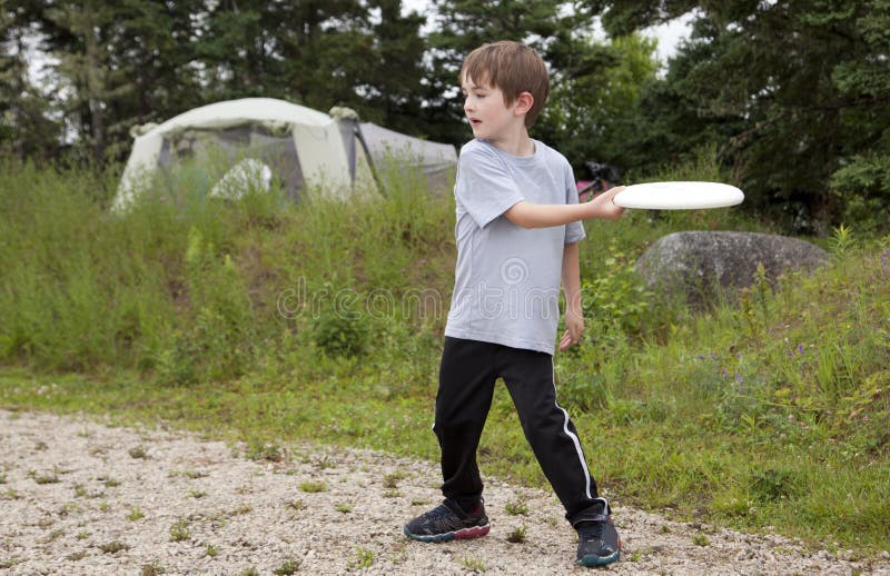 Little boy throws frisbee stock image. Image of healthy - 98220285