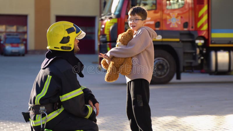 Firefighter Gives a Toy To a Rescued Child Stock Video - Video of ...