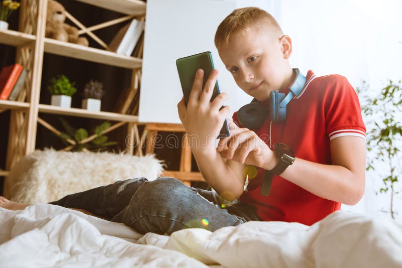 Little Boy Using Different Gadgets at Home Stock Photo - Image of ...