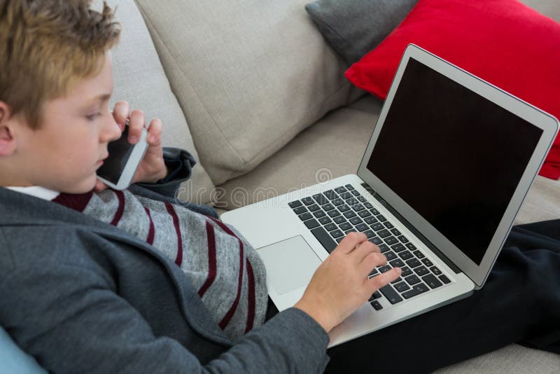 Little Boy Using Laptop on Couch Stock Image - Image of call ...