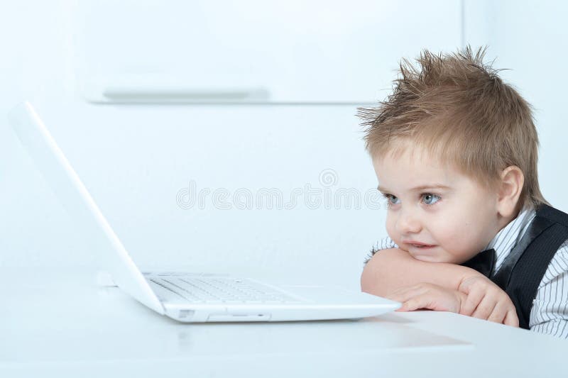 Little boy using laptop stock photo. Image of indoors - 70794482
