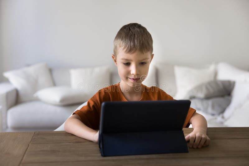 Little Boy Using Modern Digital Tablet Device at Home Stock Photo ...