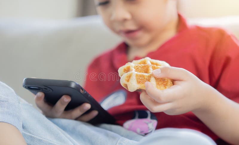 Little Boy Using Phone while Eating Waffle during Lunch or Dinner at ...