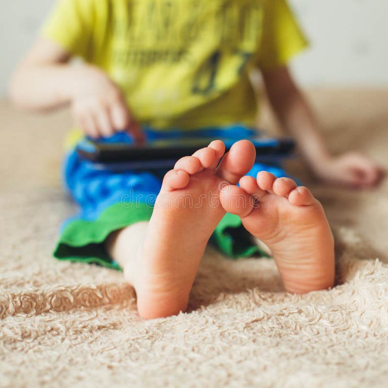 Little Boy Using Tablet on a Bed. Square Photo Stock Image - Image of ...