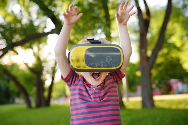 Little Boy Using Virtual Reality Headset Outdoor. VR, VR Glasses ...