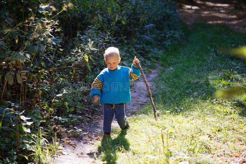 Little Boy Walking with a Cane on a Country Road Stock Image - Image of ...