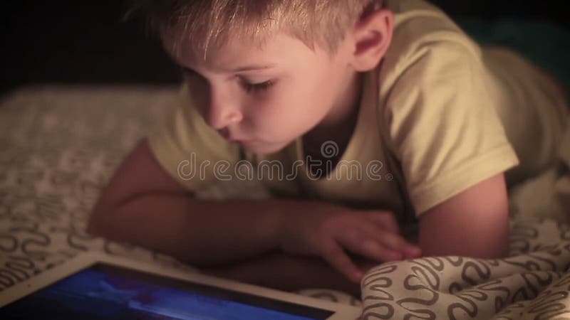 Little Boy Watching Tales on Tablet on Bed Stock Video - Video of ipad ...