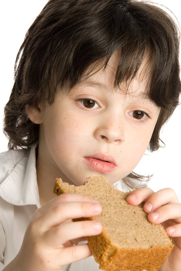 The Little Boy Which Eating a Bread on Desk Stock Photo - Image of ...