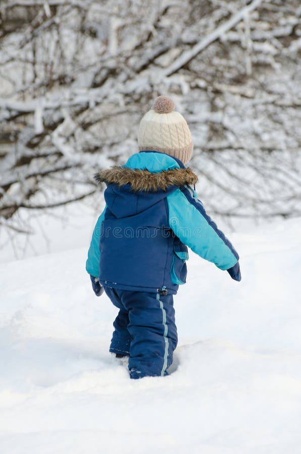 Little Boy in Winter Clothing Walking in Snow, View from the Back Stock ...