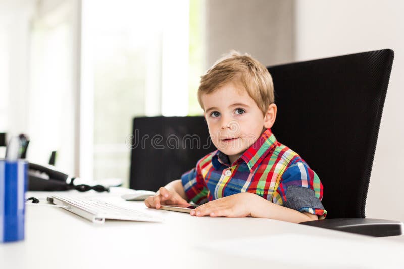 Little Boy Working in Office Stock Photo - Image of indoors, white ...