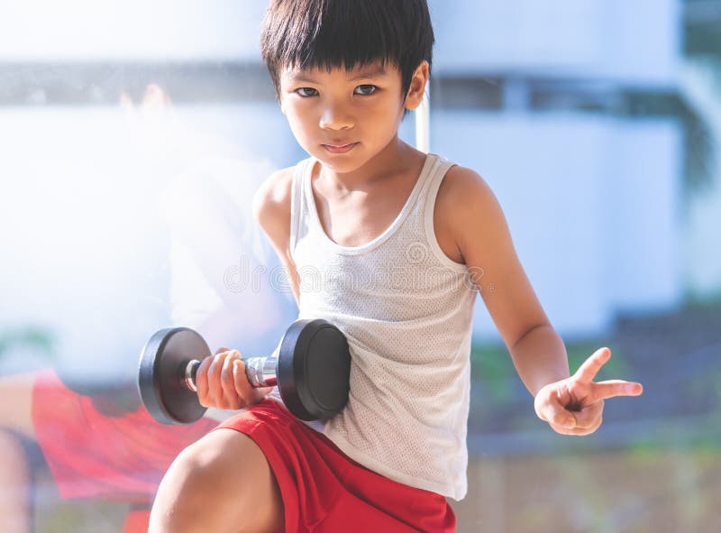 Little Boy Working Out with Dumbbell by the Windows City Stock Photo ...