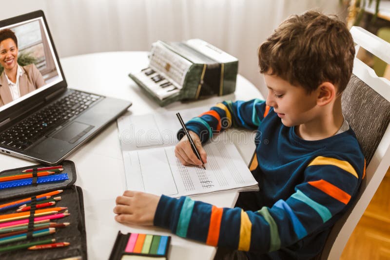 Boy Writes Musical Notes and Violin Key at Home Online Course on Laptop ...