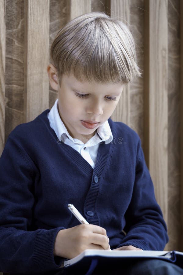 Little Boy Writes with a Pen in a Notebook. Stock Image - Image of ...