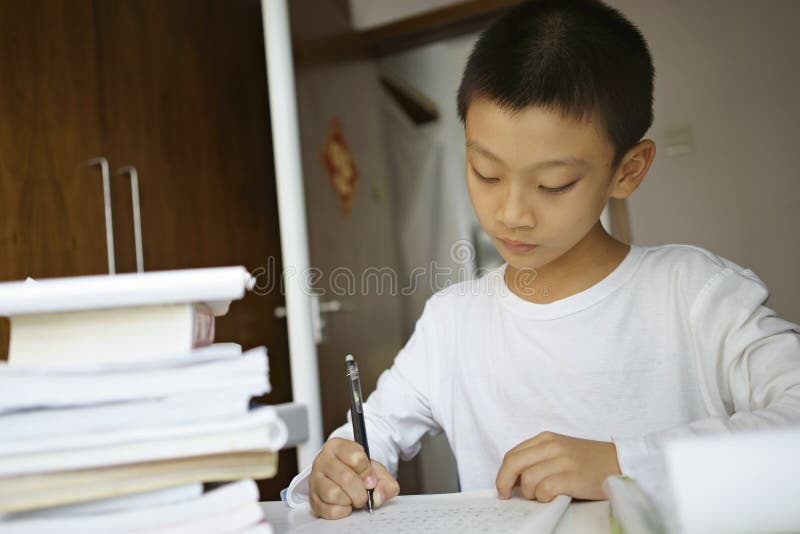 Smart Little Boy Neatly Writing Homework in His Notebook, Diligent ...