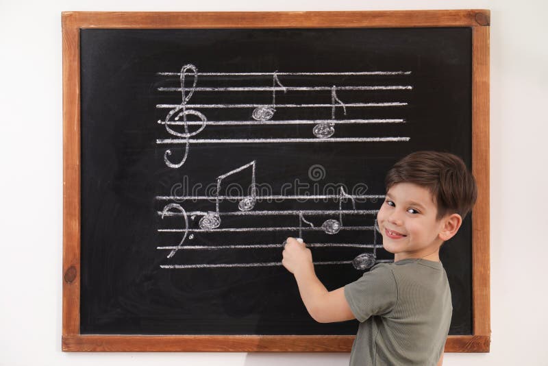 Little Boy Writing Music Notes on Blackboard Stock Photo - Image of ...