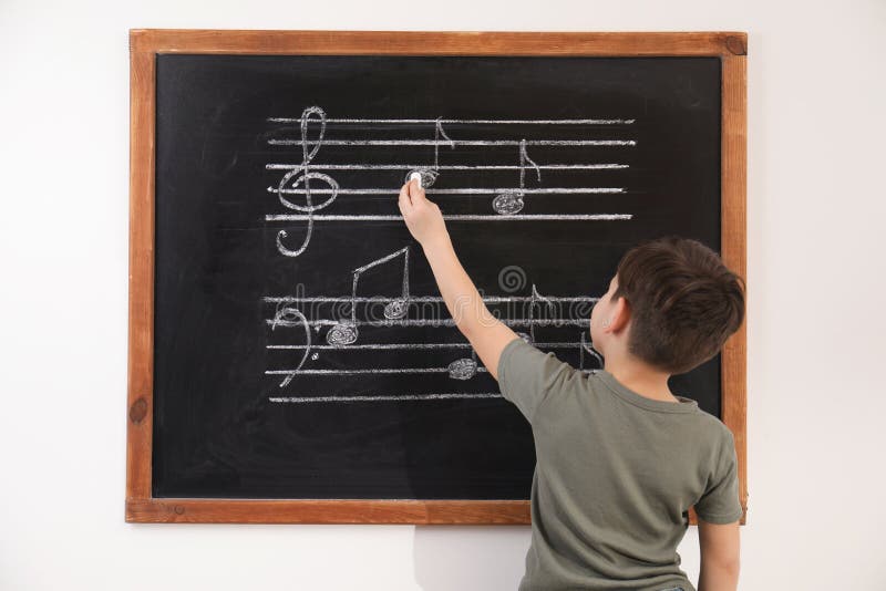 Little Boy Writing Music Notes on Blackboard Stock Image - Image of ...