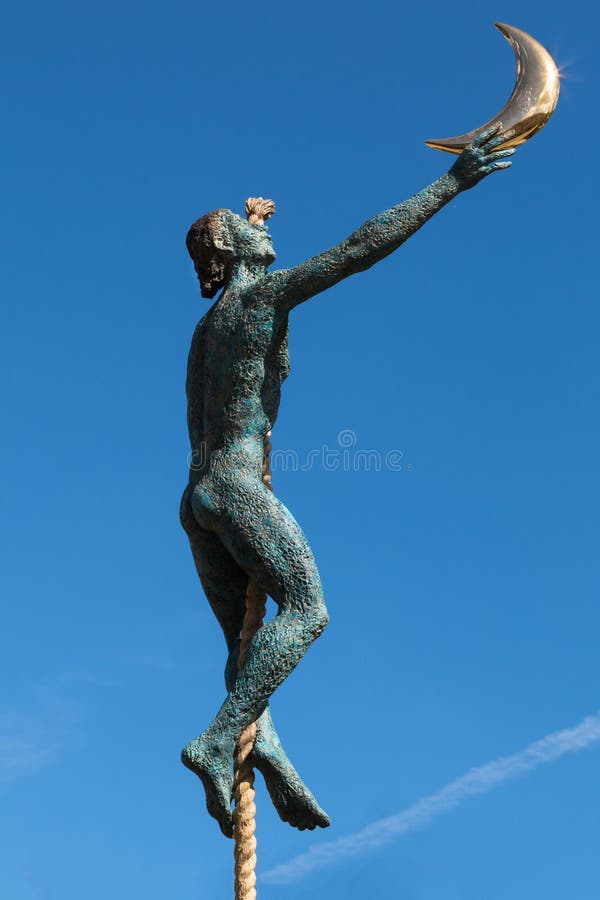 Little Bronze Statue: Man Over a Rope Catching the Moon Stock Photo ...