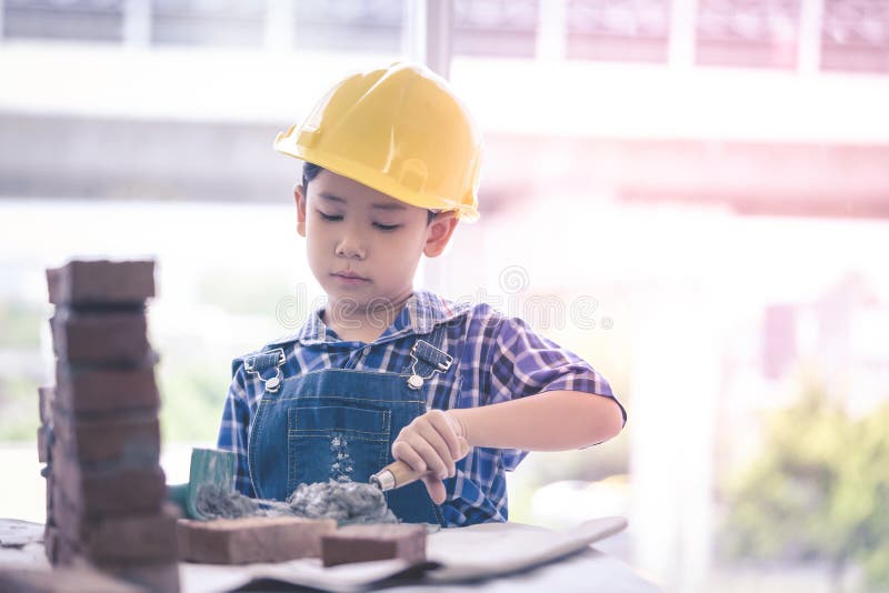 Little Builder Boy Learning How To Build Brick Wall in Vintage Tone ...