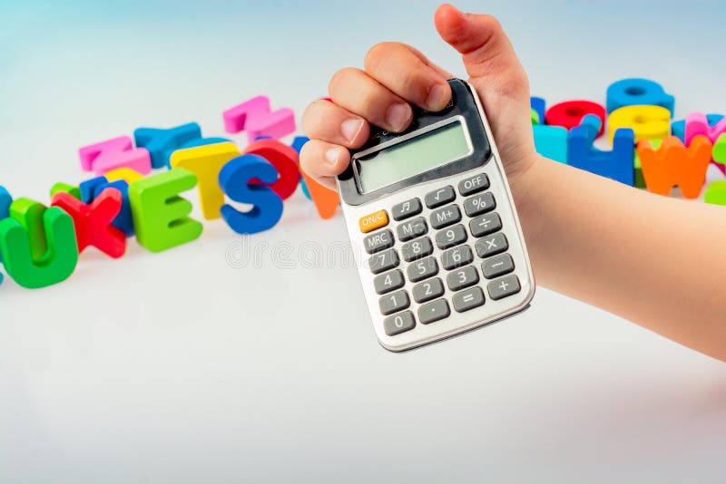 Little Calculator in Hand with Colorful Letters Behind Stock Photo ...