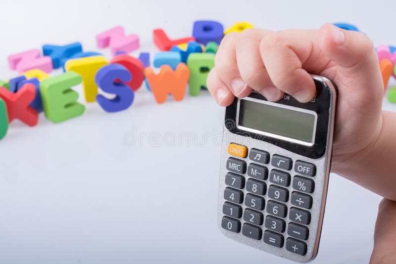 Little Calculator in Hand with Colorful Letters Behind Stock Image ...