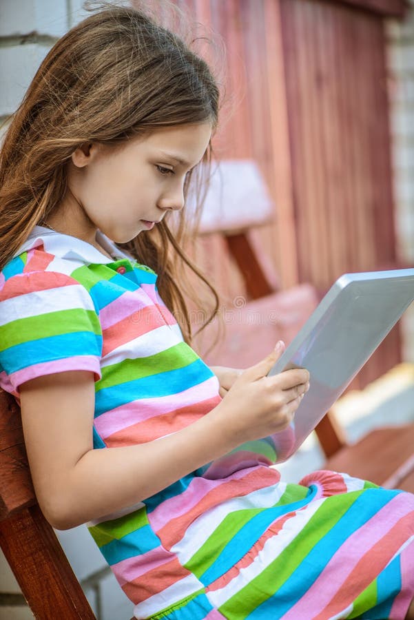 Little Calm Girl Playing on Tablet PC Stock Photo - Image of childhood ...