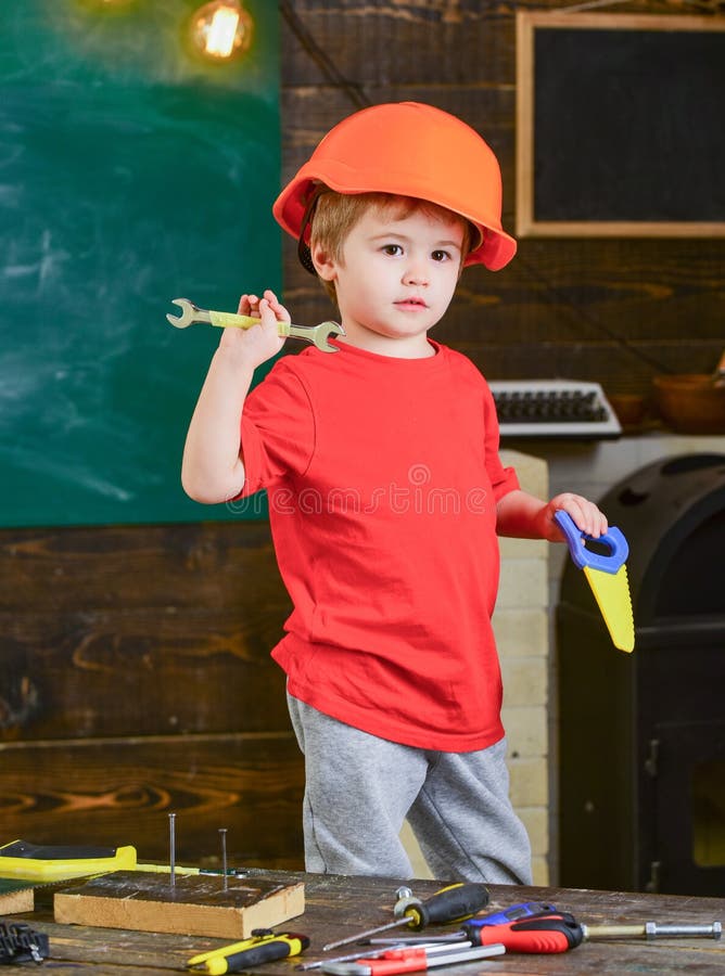 Little Carpenter Helping in Workshop. Kid Playing with Handsaw and ...