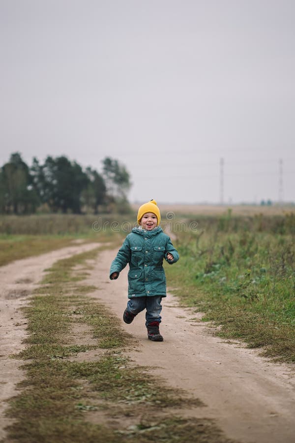 Little Caucasian Boy Running in the Field Making Funny Faces Stock ...
