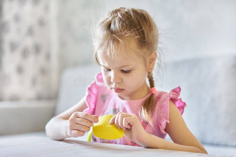 A Little Caucasian Girl Learns To Sew with a Needle and Thread. Stock ...