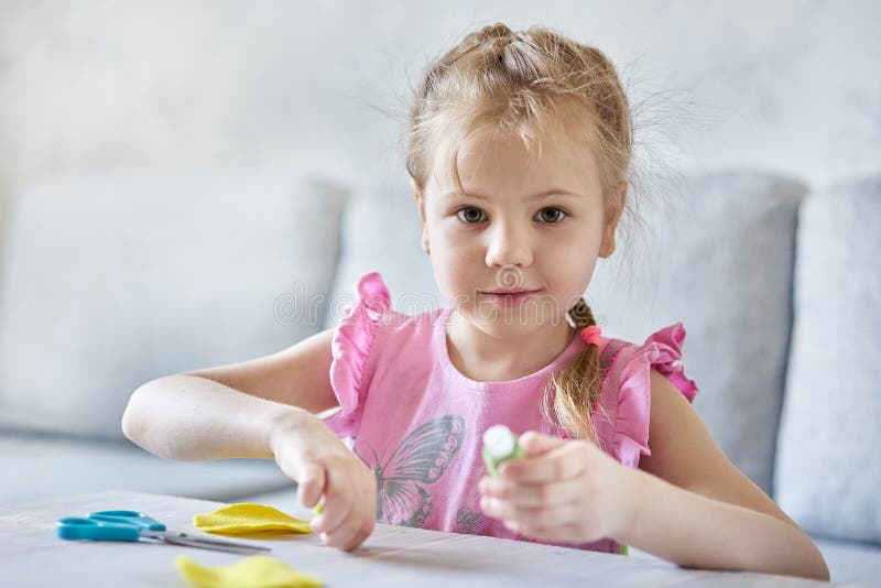 A Little Caucasian Girl Learns To Sew with a Needle and Thread. Stock ...