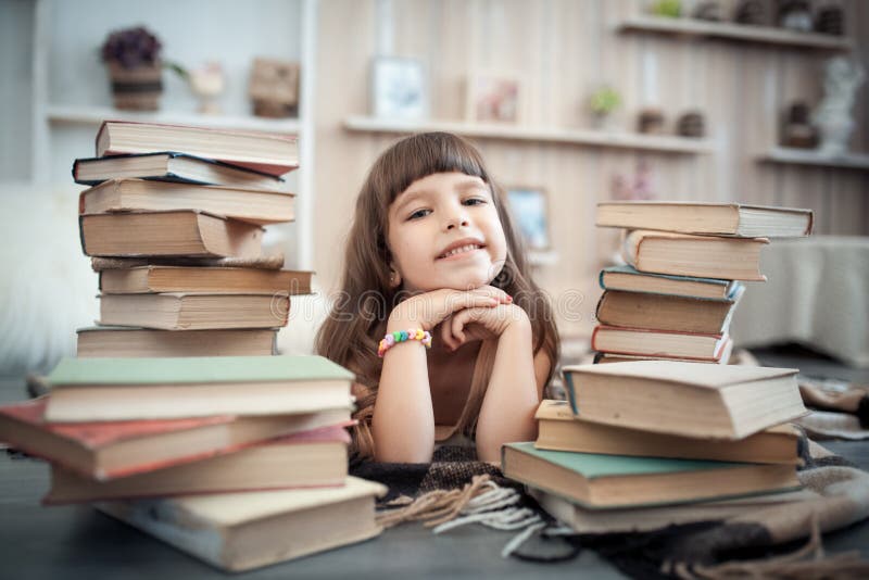 Little Cheerful Girl with Stack of Books in Library; Stock Image ...