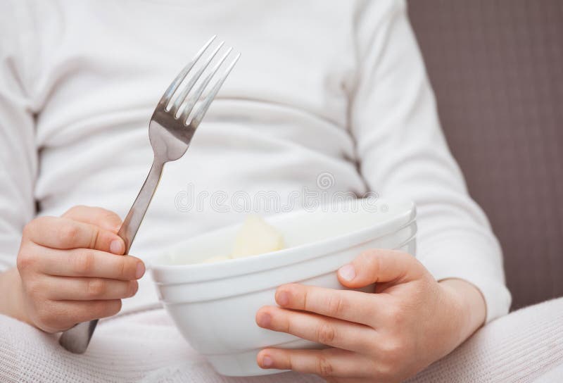 Little Child Holding a Fork and a White Bowl with Food Stock Image ...
