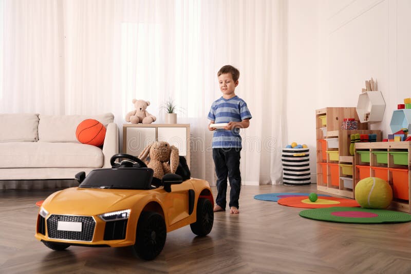 Little Child Playing with Remote Control Car in Room Stock Image ...