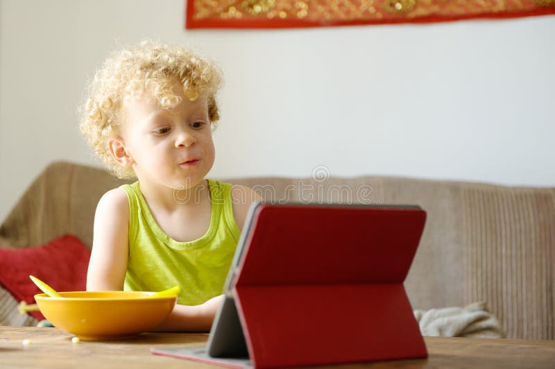 A Little Child Playing with a Tablet Stock Image - Image of person ...