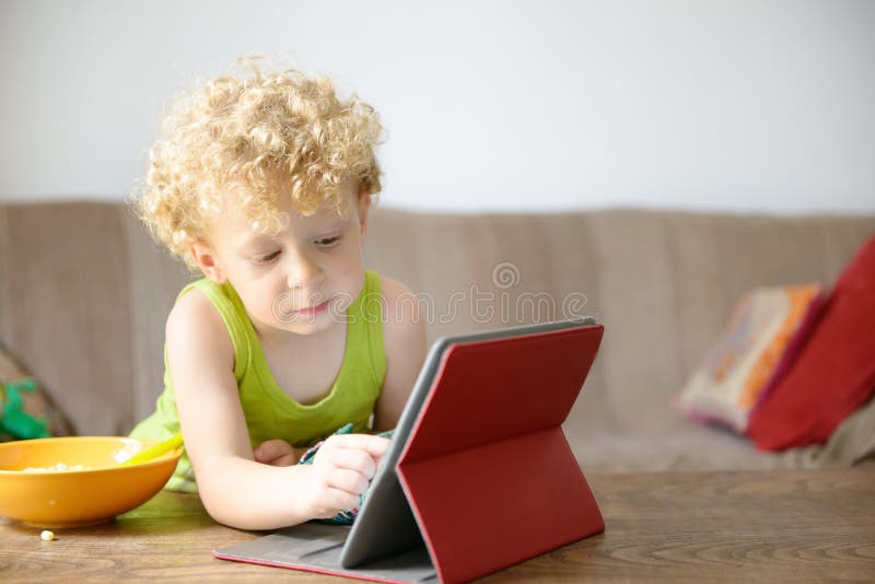 A Little Child Playing with a Tablet Stock Photo - Image of lifestyle ...