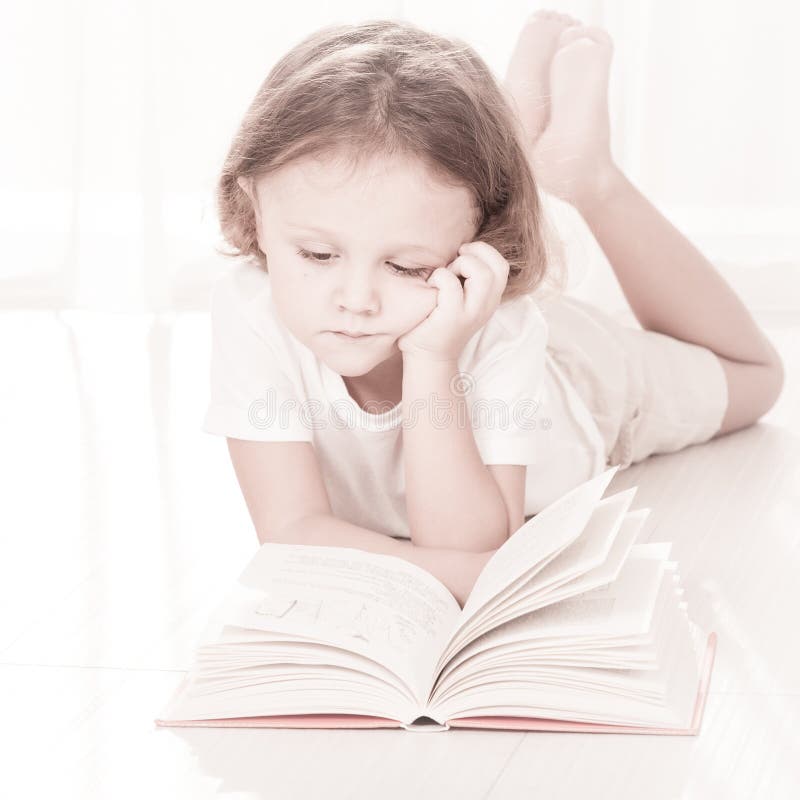 Little Child Reading Book Lying Down Stock Image - Image of learning ...