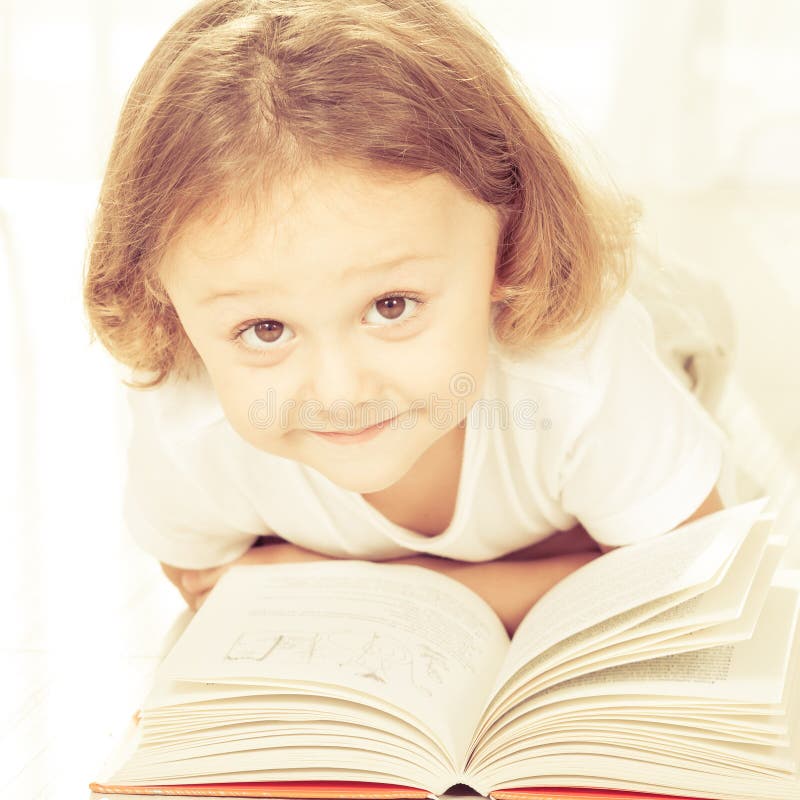 Little Child Reading Book Lying Down Stock Image - Image of beautiful ...